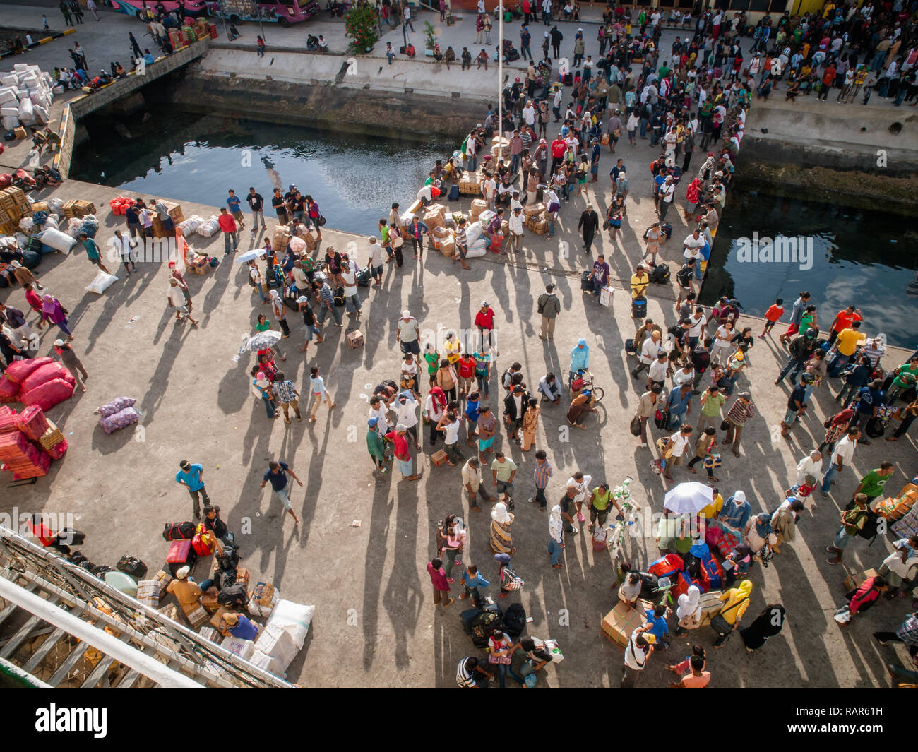 View from boat on pier full of people at Indonesia, Ambon island Stock ...