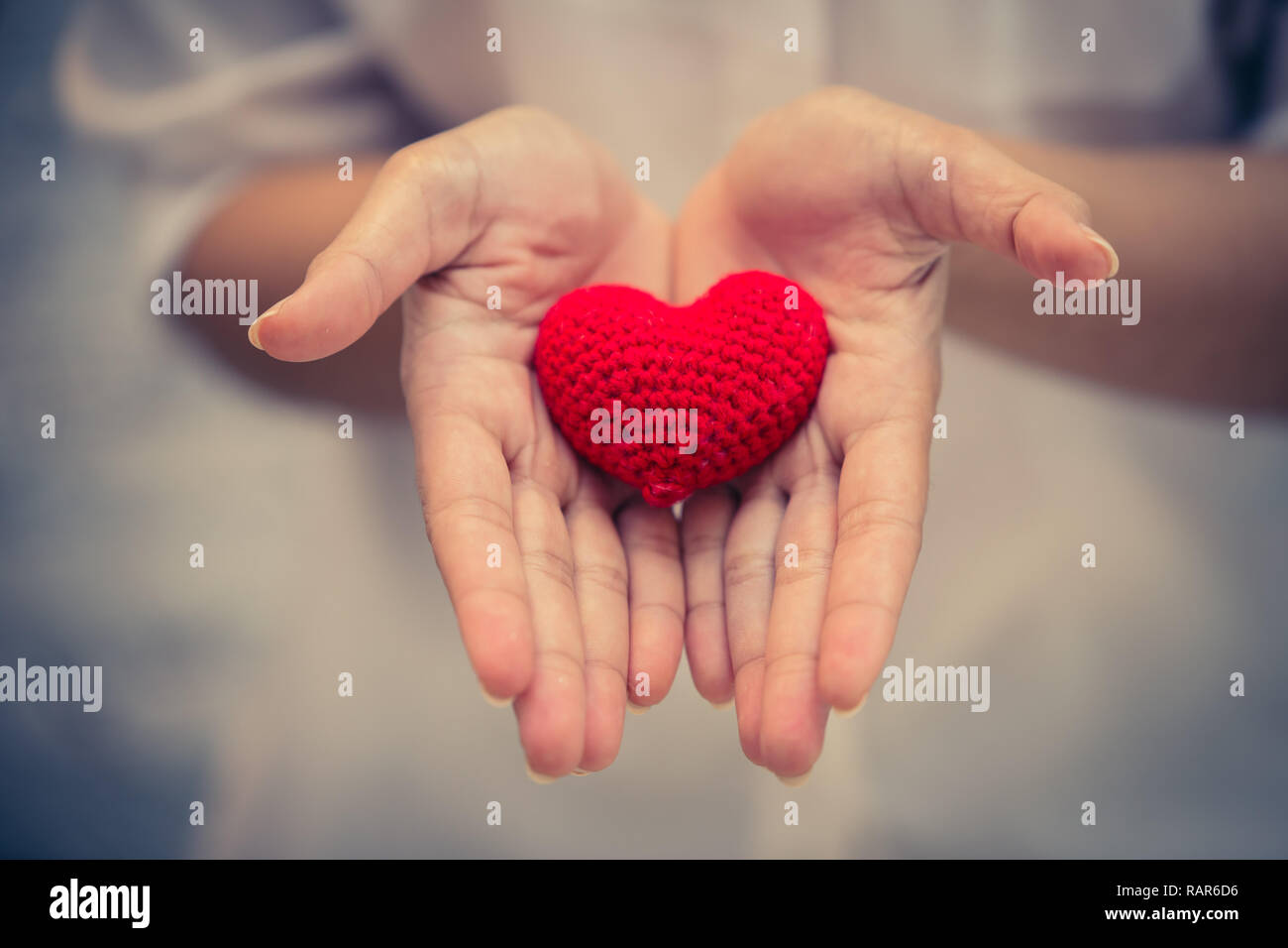 closeup girl hand giving heart vintage tone Stock Photo - Alamy