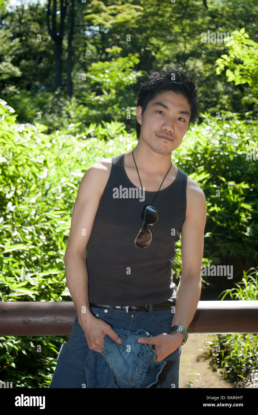 Asian male model poses for pictures on the street Stock Photo - Alamy
