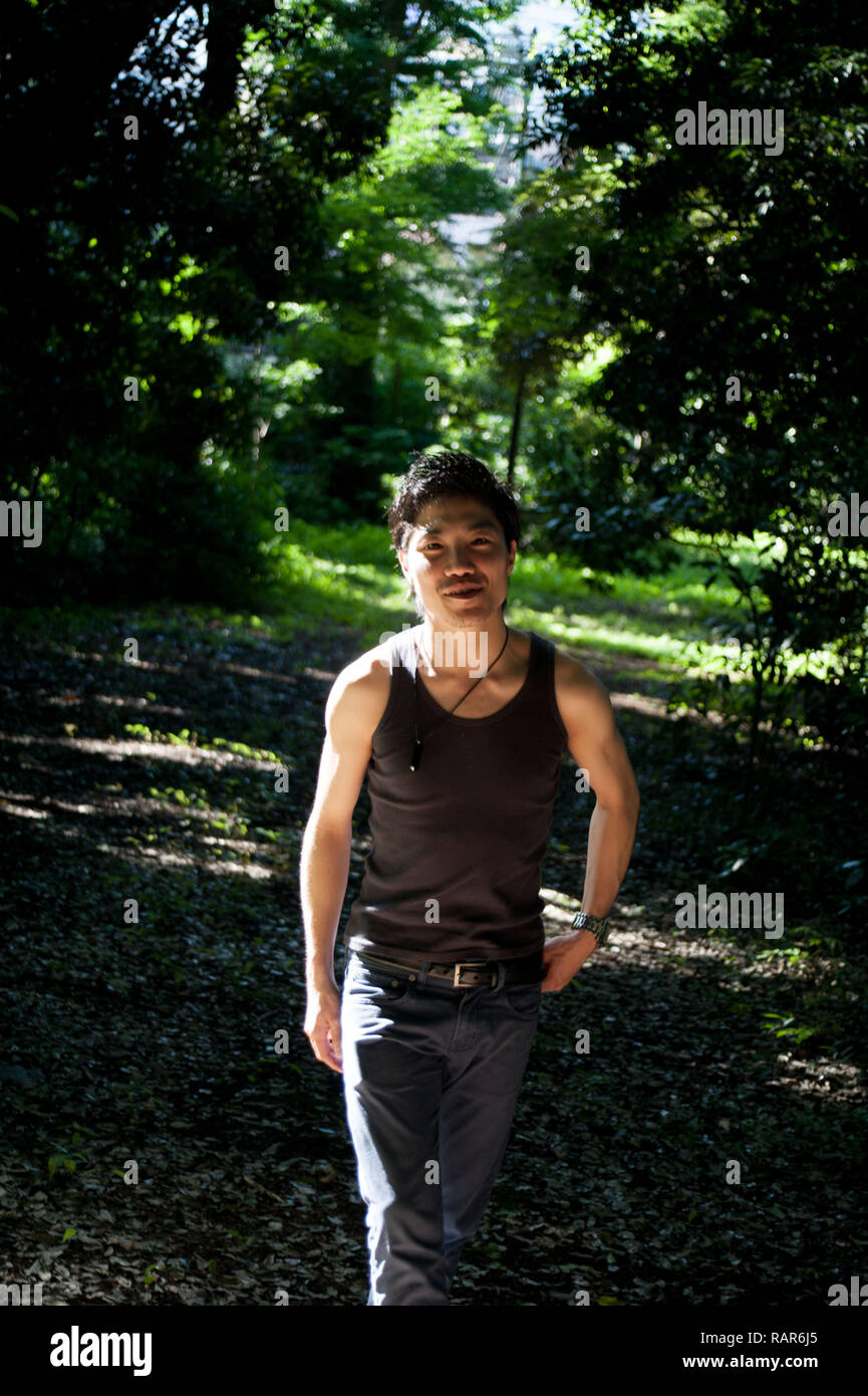 Asian male model poses for pictures on the street Stock Photo - Alamy