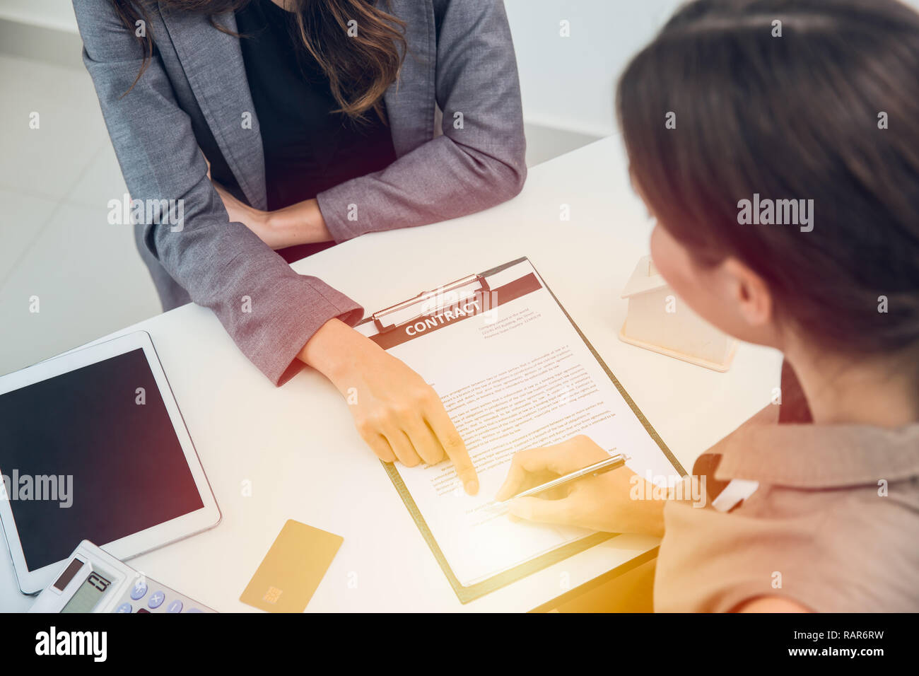 business women sign contract Stock Photo - Alamy