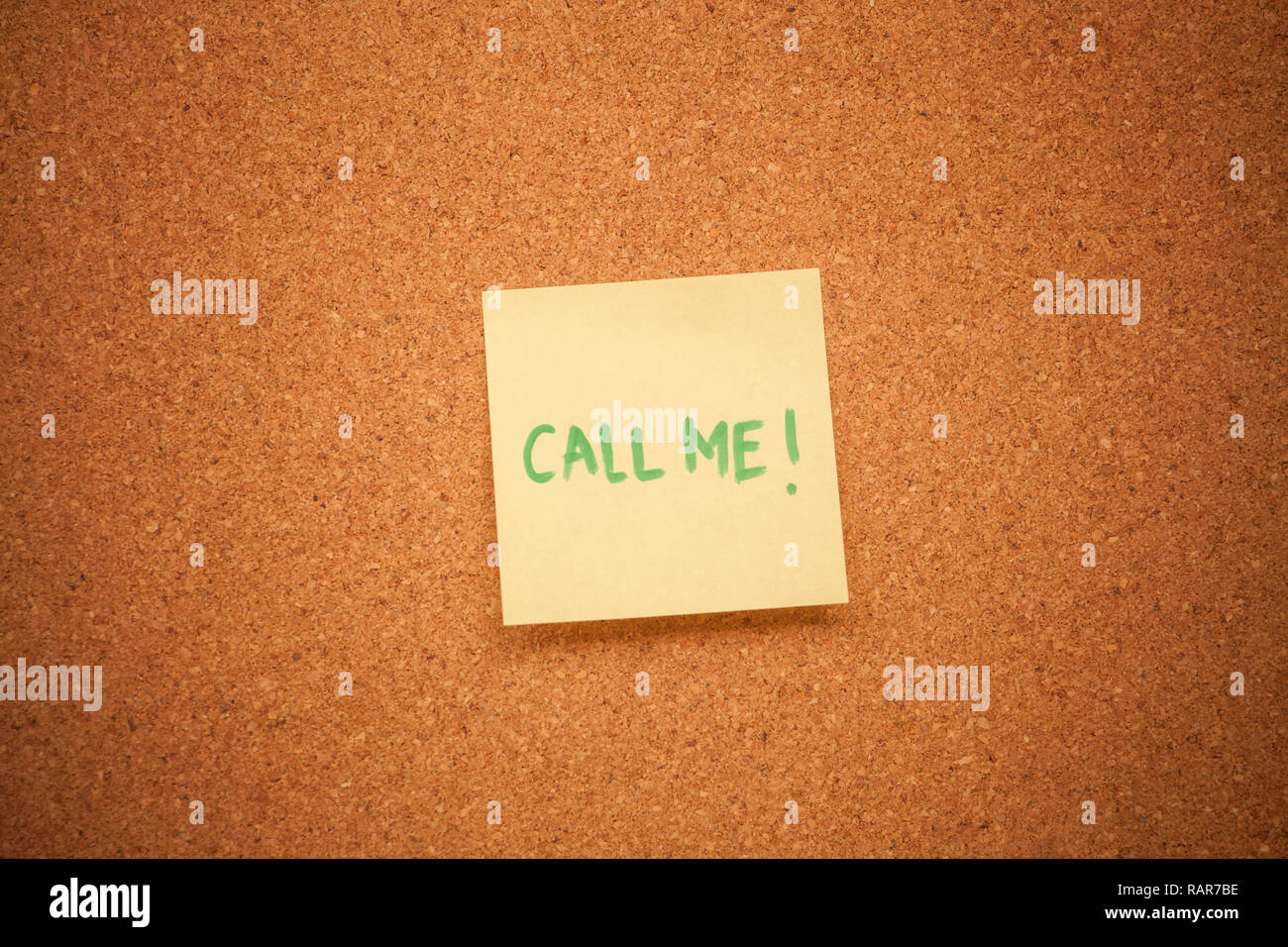 A call me sticky note on a cork board Stock Photo - Alamy