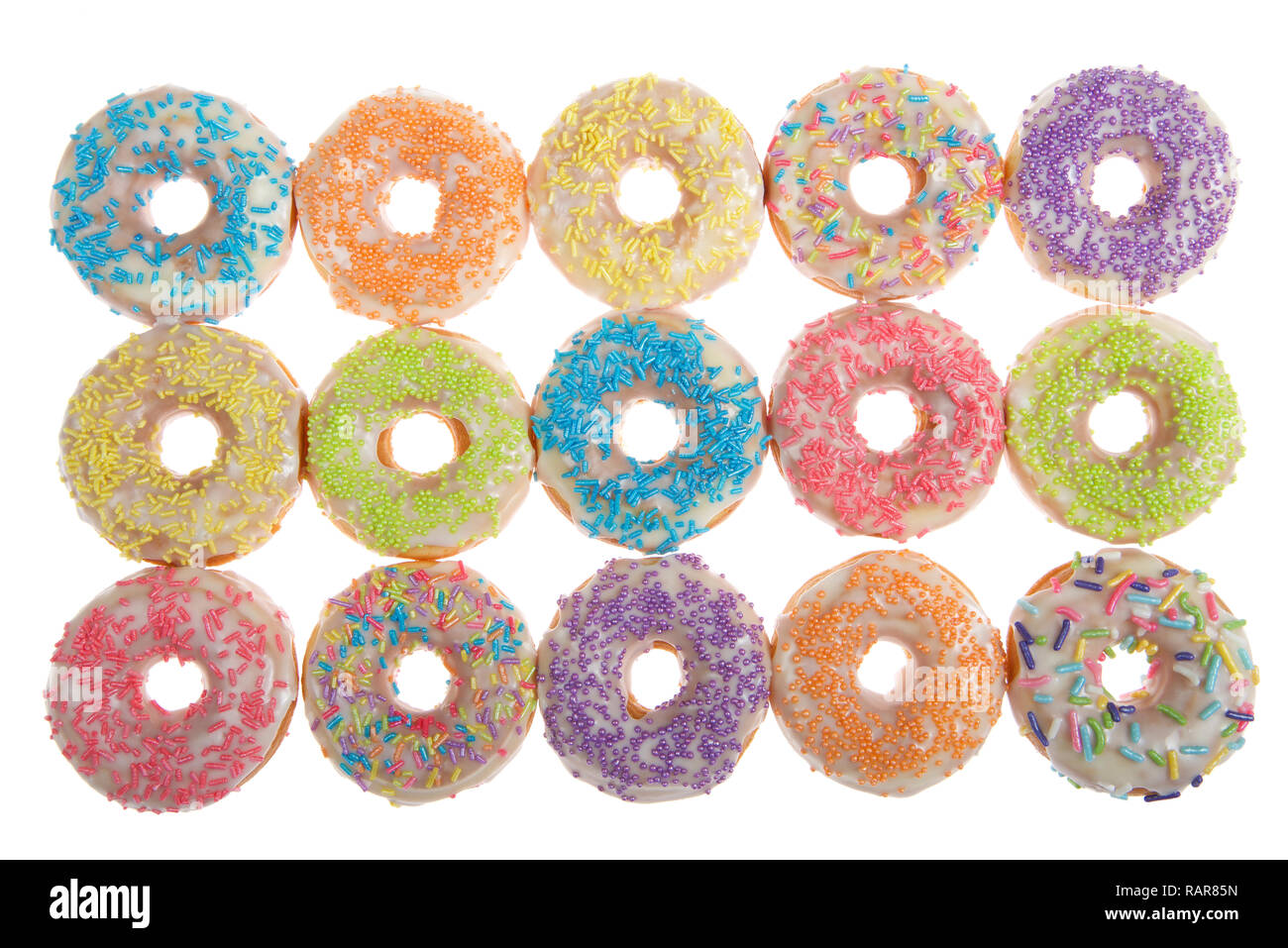 Flat lay view of many Frosted donuts with candy sprinkles isolated on ...