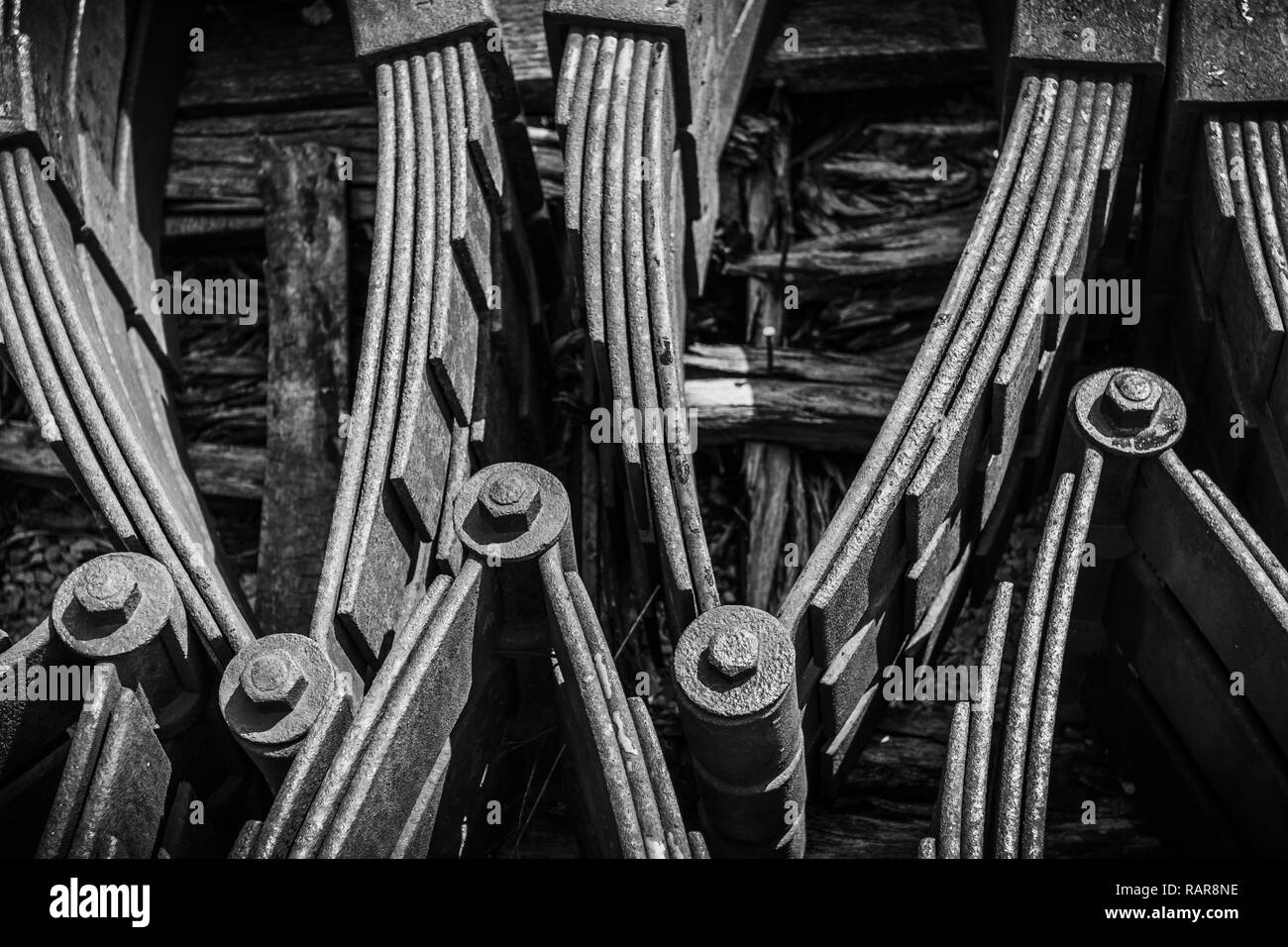 Close-up black and white photo of a pile of railroad car leaf springs ...