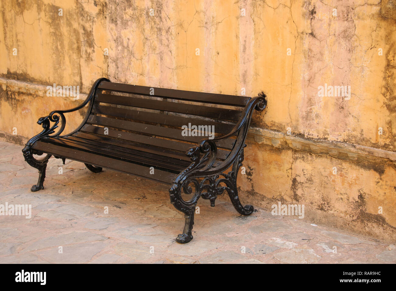 The bench near the yellow wall Stock Photo - Alamy