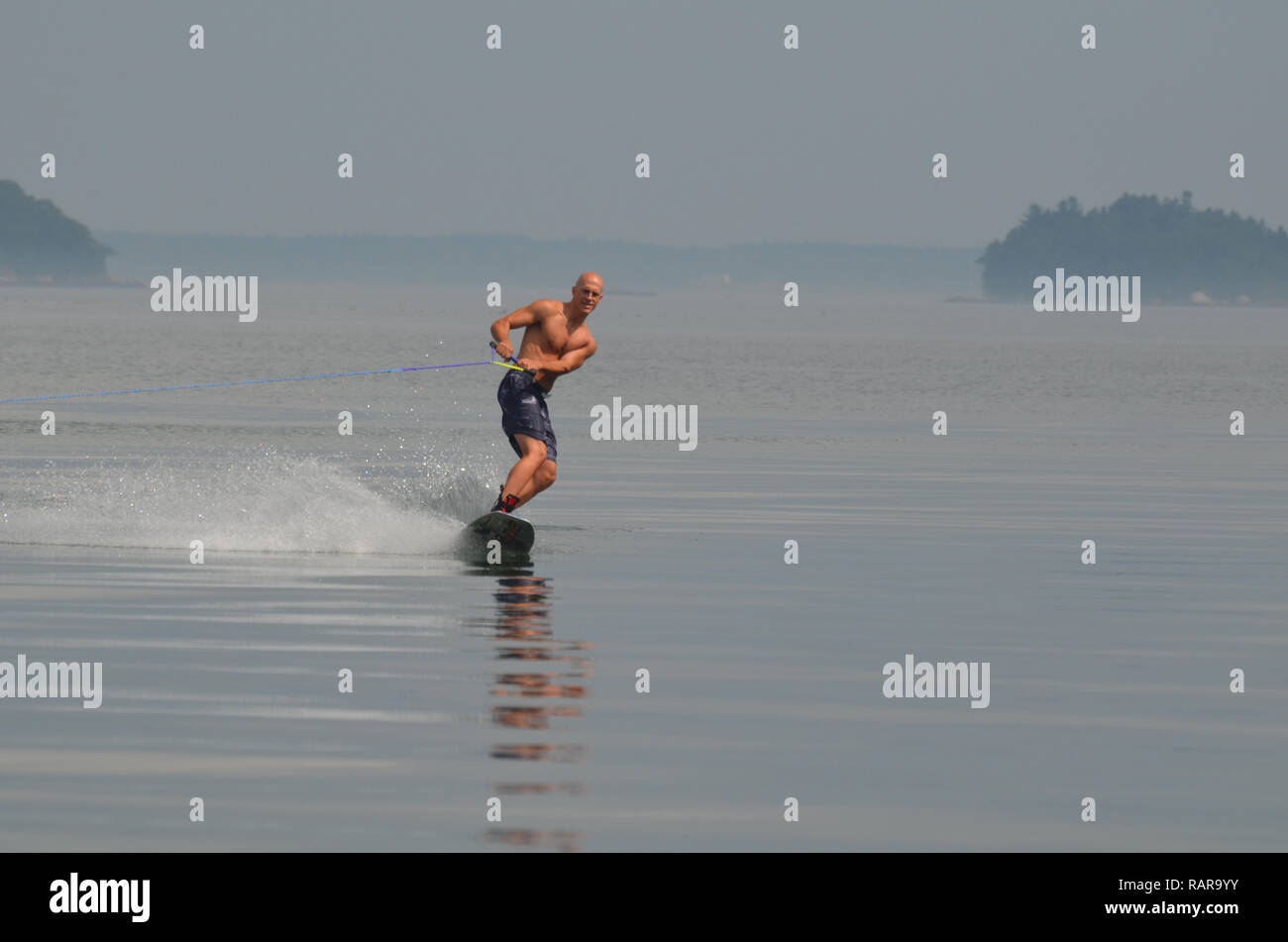 Athletic guy wakeboarding on the calm waters of Casco Bay Maine Stock ...