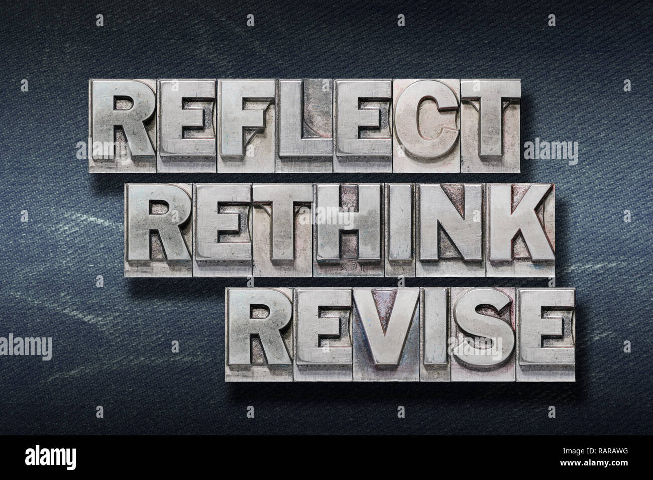 reflect rethink revise words made from metallic letterpress on dark ...