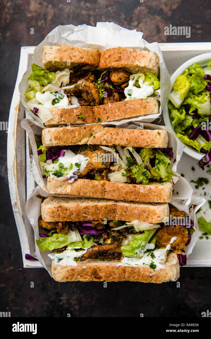 delicious gyros sandwich in paper bag with salad and tzatziki, top view ...