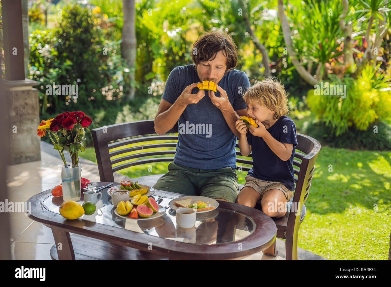 family of two eating nicely served breakfast outside handsome young man ...