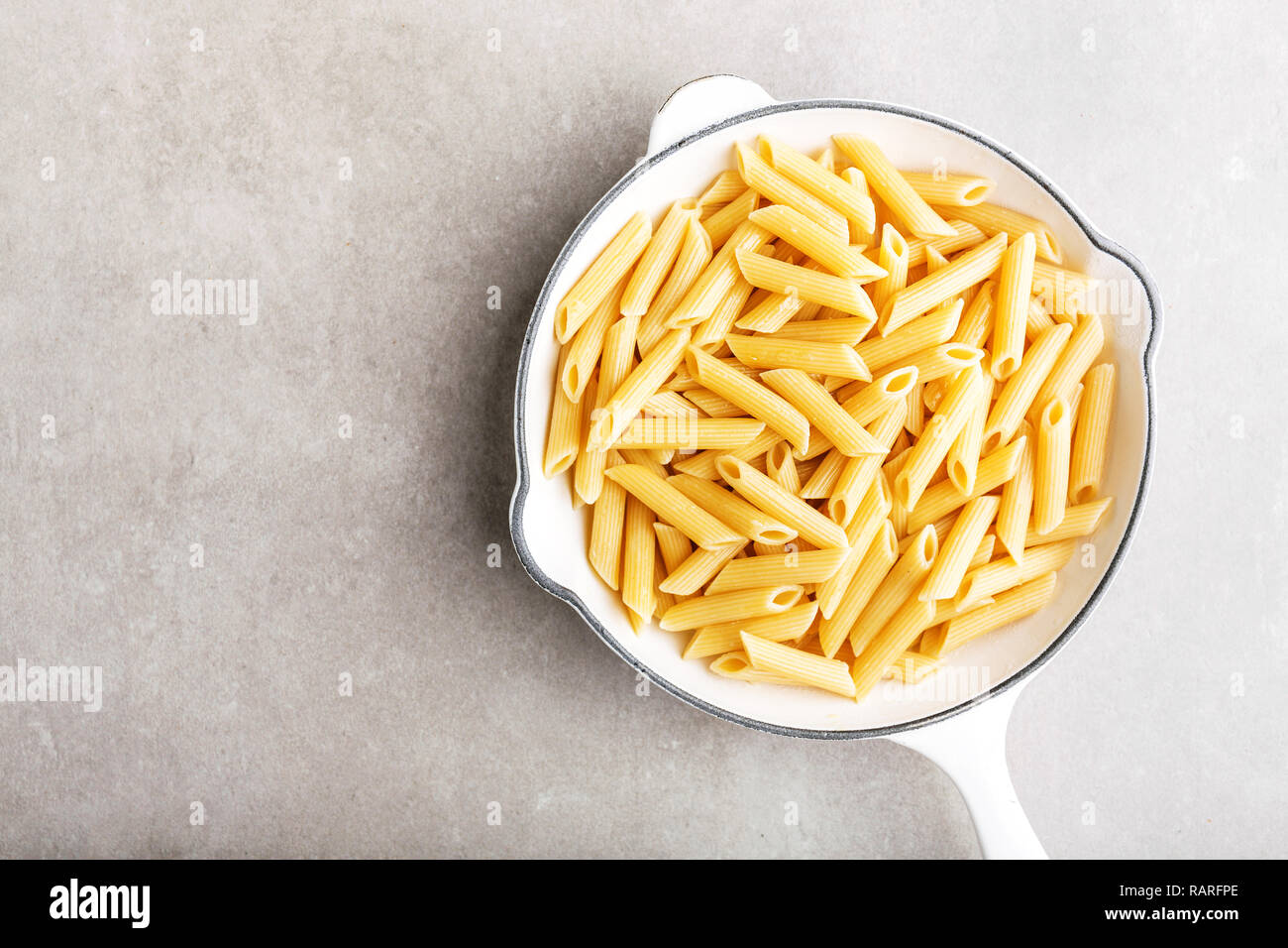 Cooked italian pasta penne served in white pan. Simple food. View from ...
