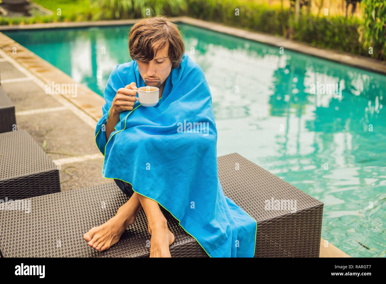 Sick man traveler. The man caught a cold on vacation, sits sad at the ...