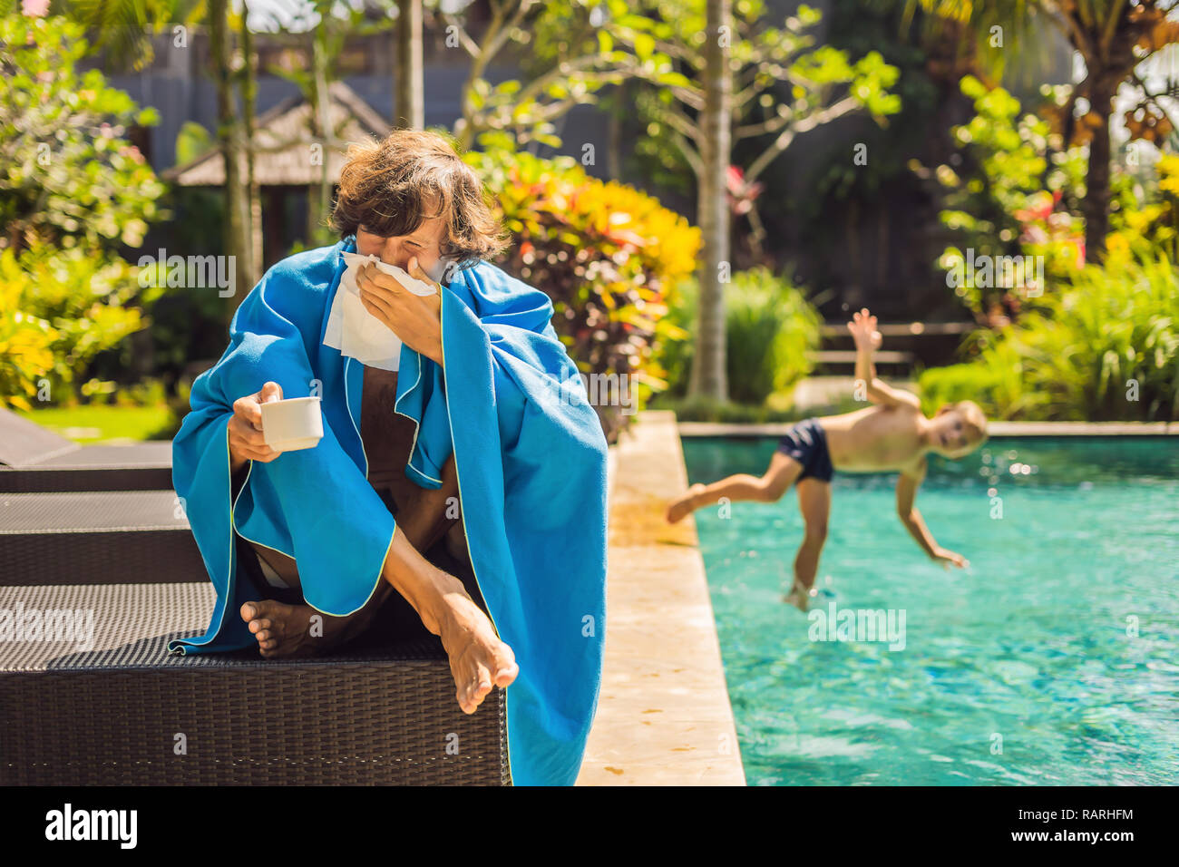 Sick man traveler. The man caught a cold on vacation, sits sad at the ...