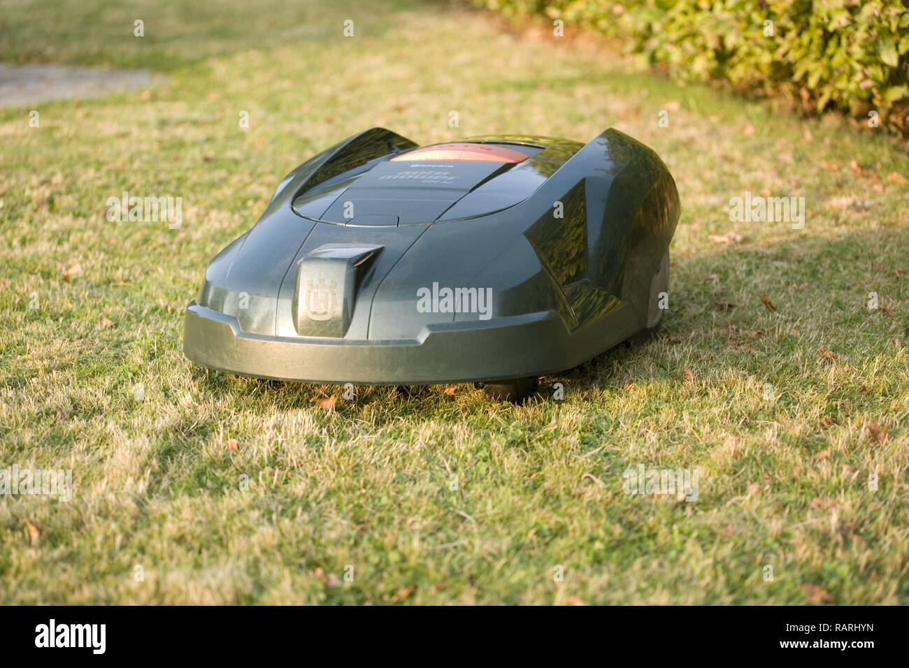 Automatic robot lawn mower cutting grass and heading towards camera ...
