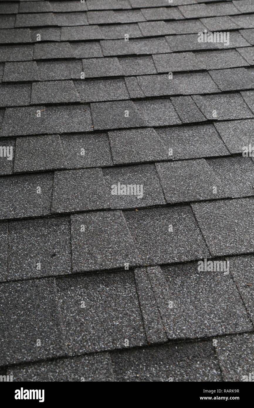 Tab styled asphalt roof shingles Stock Photo - Alamy
