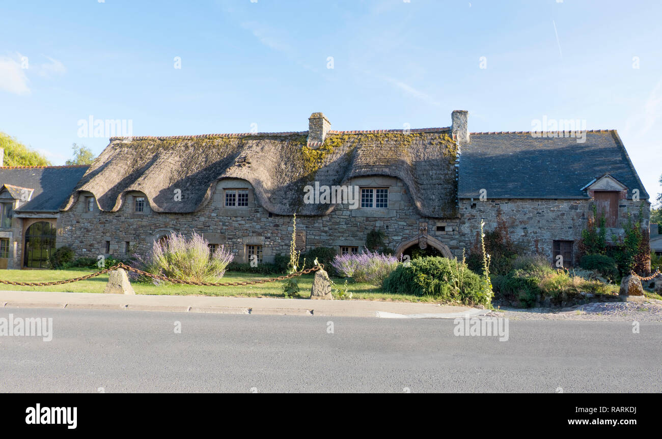 Old beautiful traditional stone house with thatched roof in Brittany ...