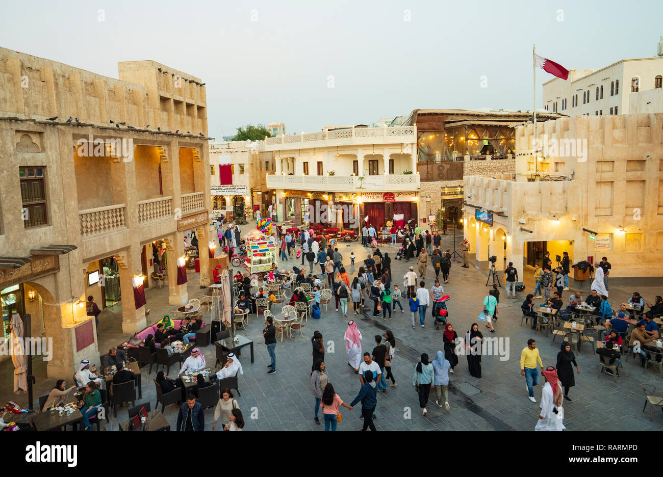 Evening view of street busy with people in Souq Waqif in Doha, Qatar ...