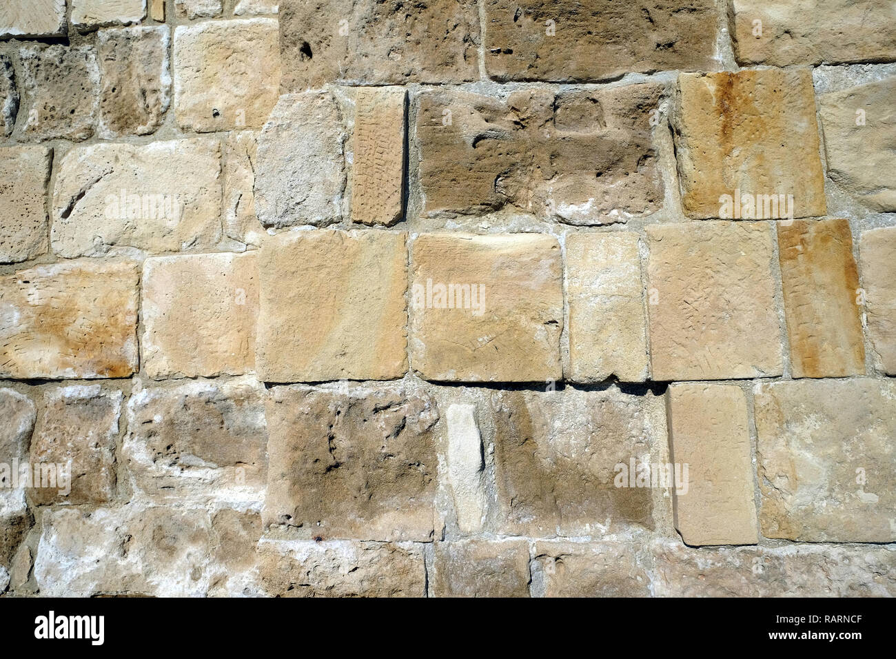 Vintage antique wall from old sandy limestone as background front view ...