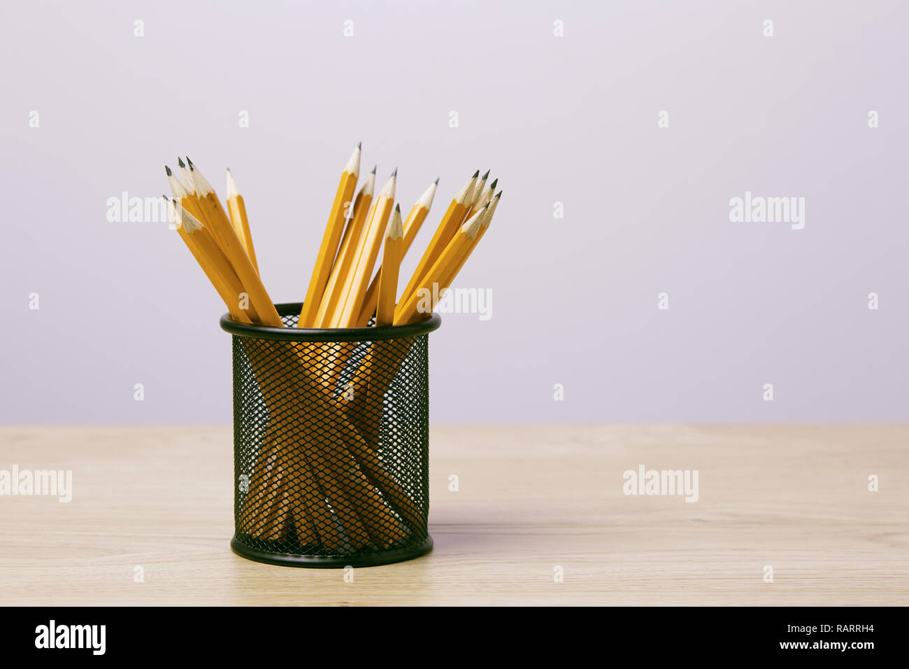 Graphite pencils in a metal grid-container. Concept Stock Photo - Alamy