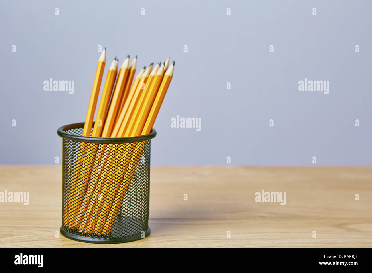 Graphite pencils in a metal grid-container. Concept Stock Photo - Alamy