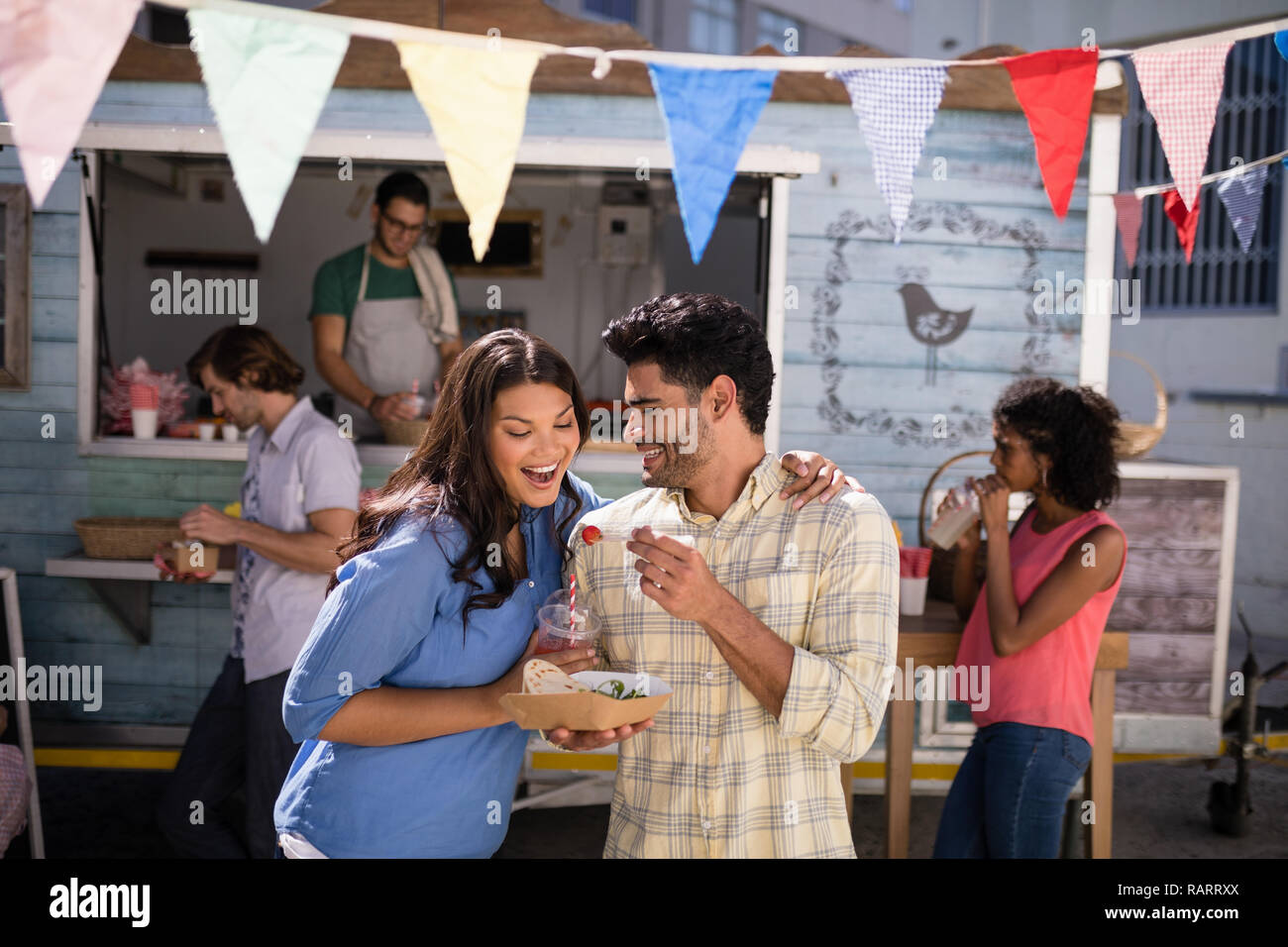 Man feeding snacks to woman Stock Photo - Alamy