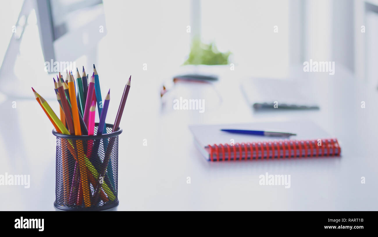 Graphite pencils in a metal grid-container on the office table. Concept ...
