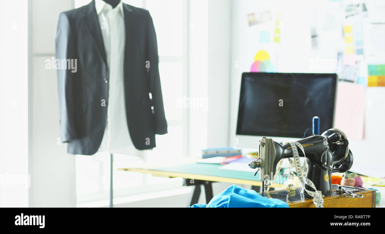Retro sewing machine on designer clothes desktop Stock Photo - Alamy