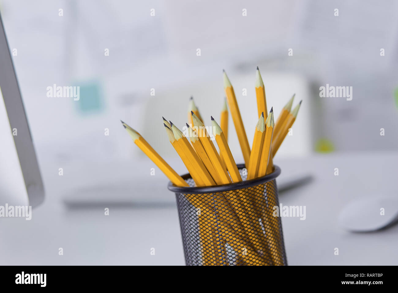 Graphite pencils in a metal grid-container. Concept Stock Photo - Alamy