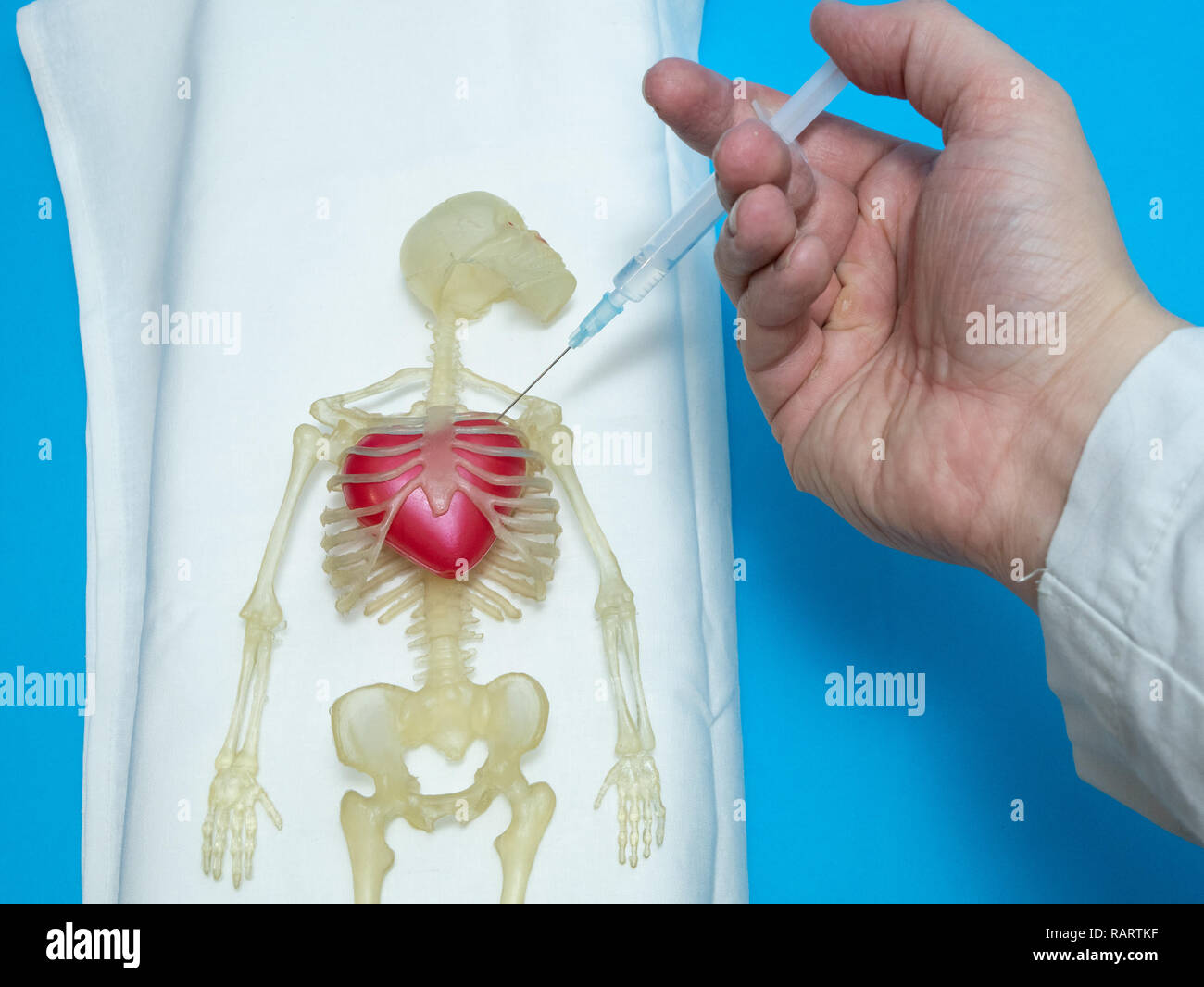 doctor making injection in red heart to patient concept Stock Photo - Alamy
