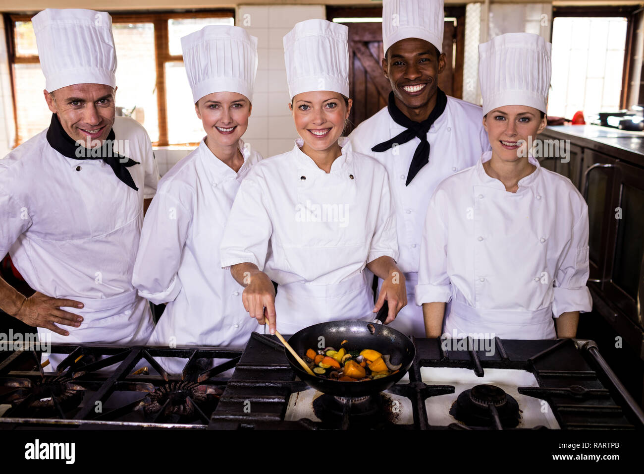 Female chef preparing food in kitchen Stock Photo - Alamy