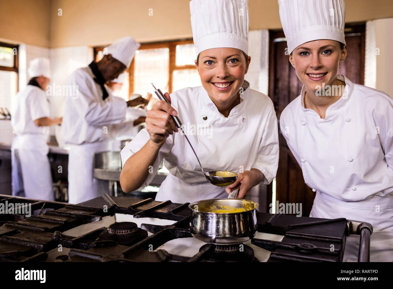 Two chefs cooking in kitchen hi-res stock photography and images - Alamy