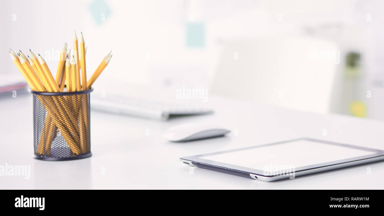 Graphite pencils in a metal grid-container on the office table. Concept ...