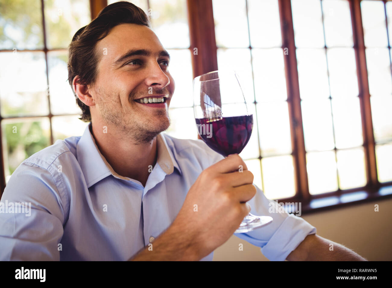 Man holding up red wine glass hi-res stock photography and images - Alamy