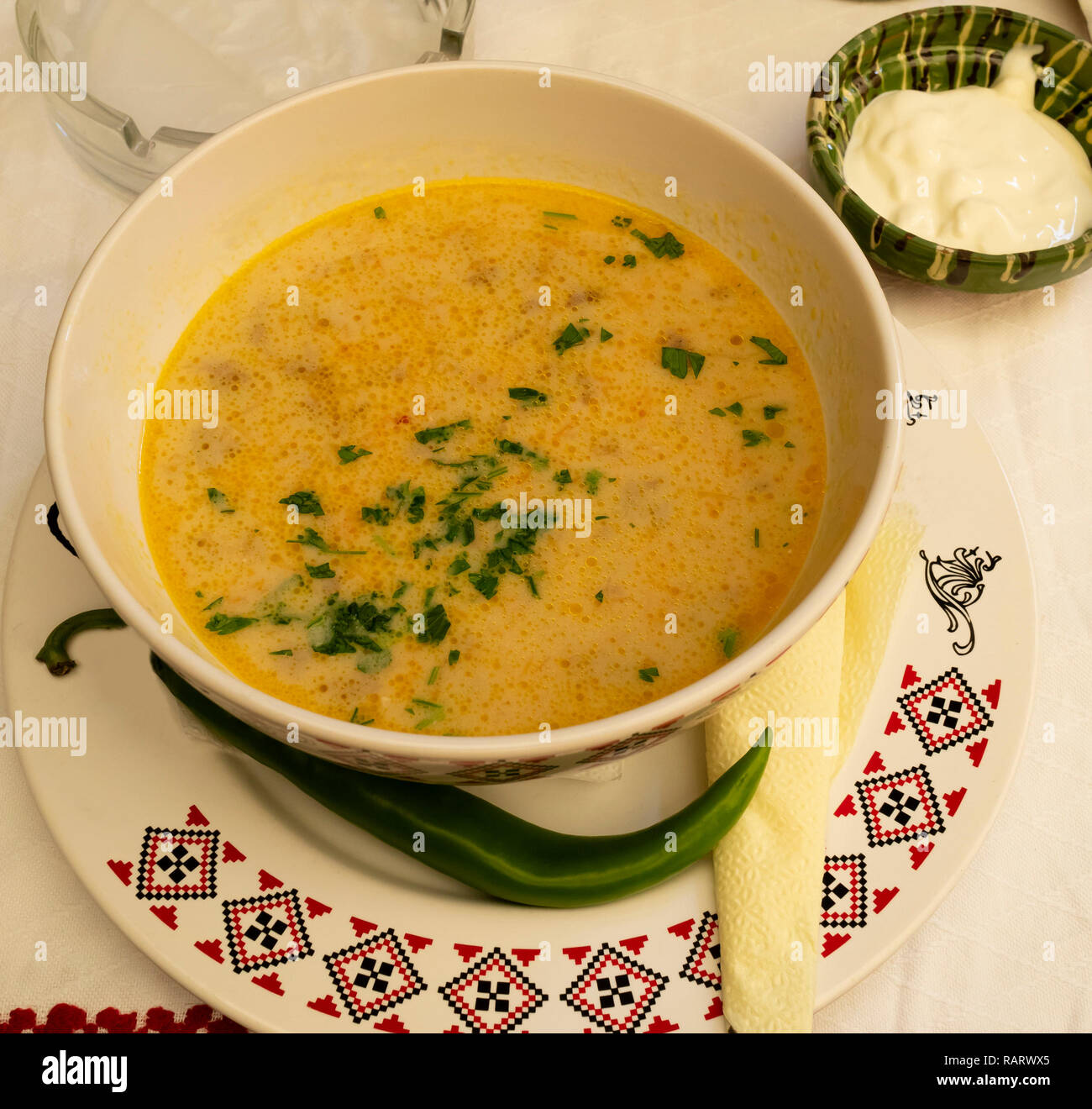 A romanian corn soup with sour cream on the side Stock Photo - Alamy