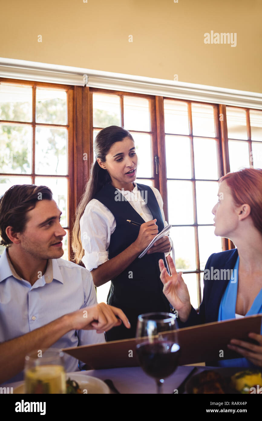 Waitress taking food order from business people Stock Photo - Alamy