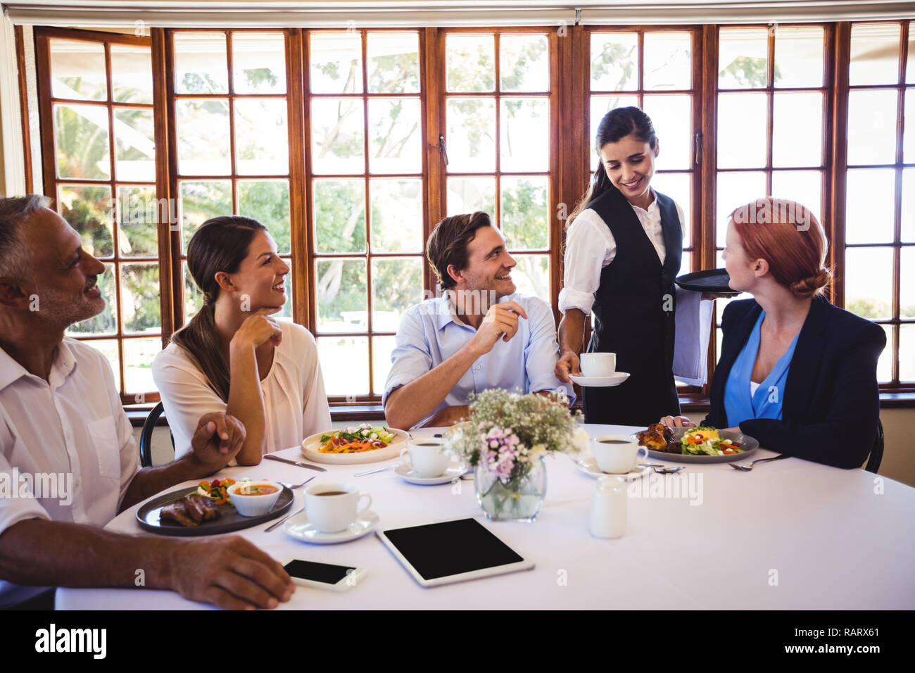 Waitress serving at table hi-res stock photography and images - Alamy