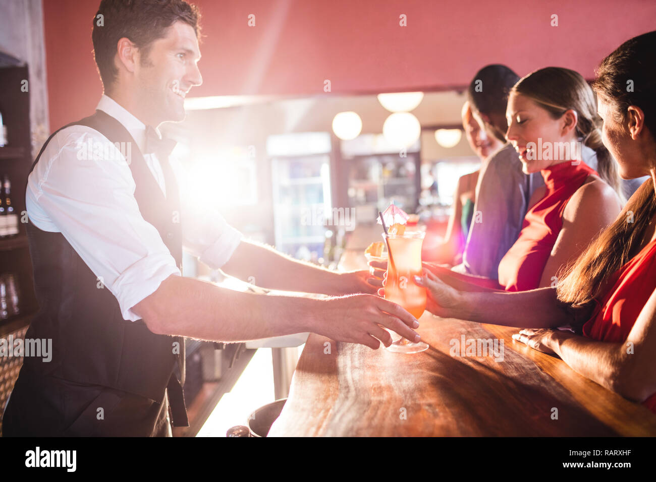 Bartender serving drinks to customer Stock Photo - Alamy