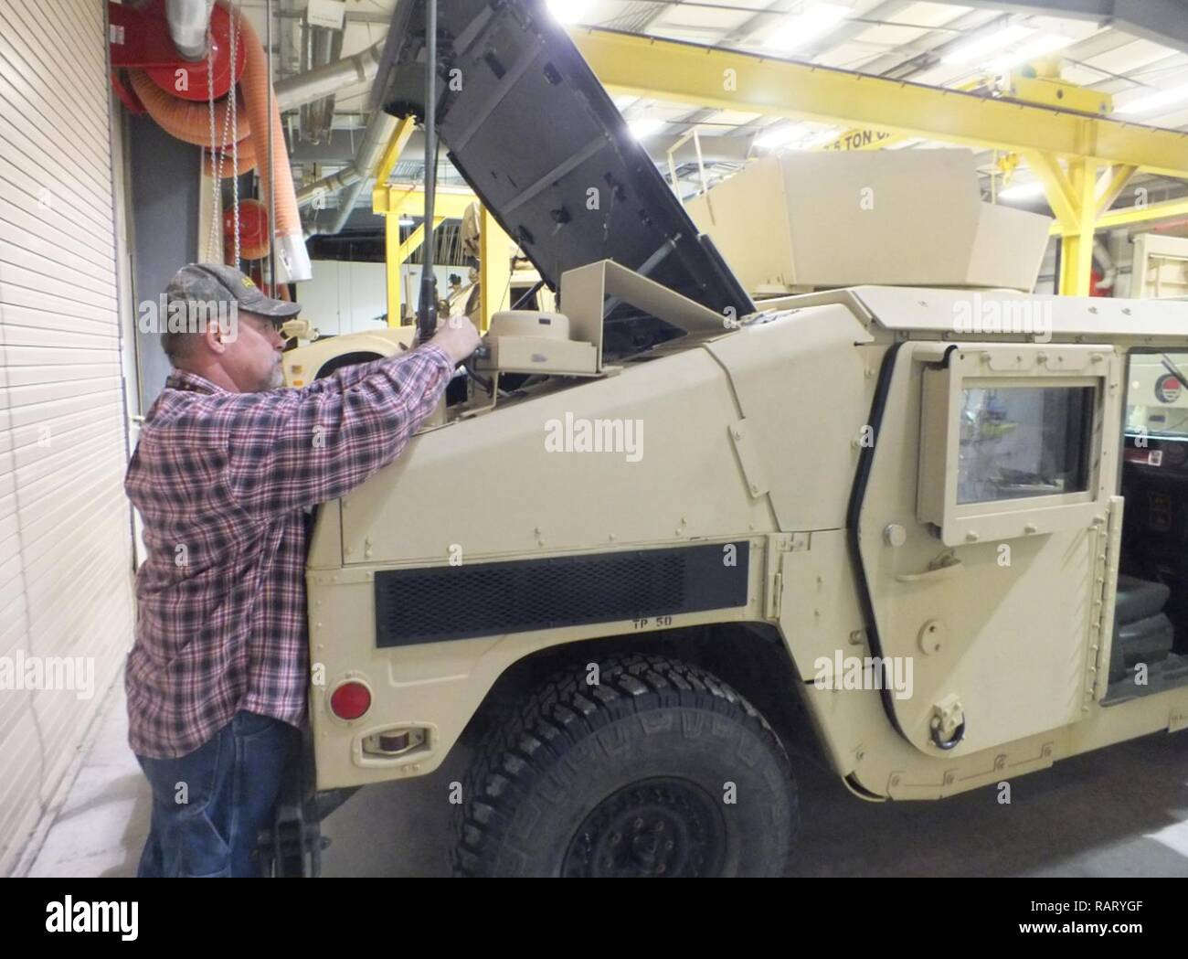 An integrator works on a vehicle in support of Network Integration ...