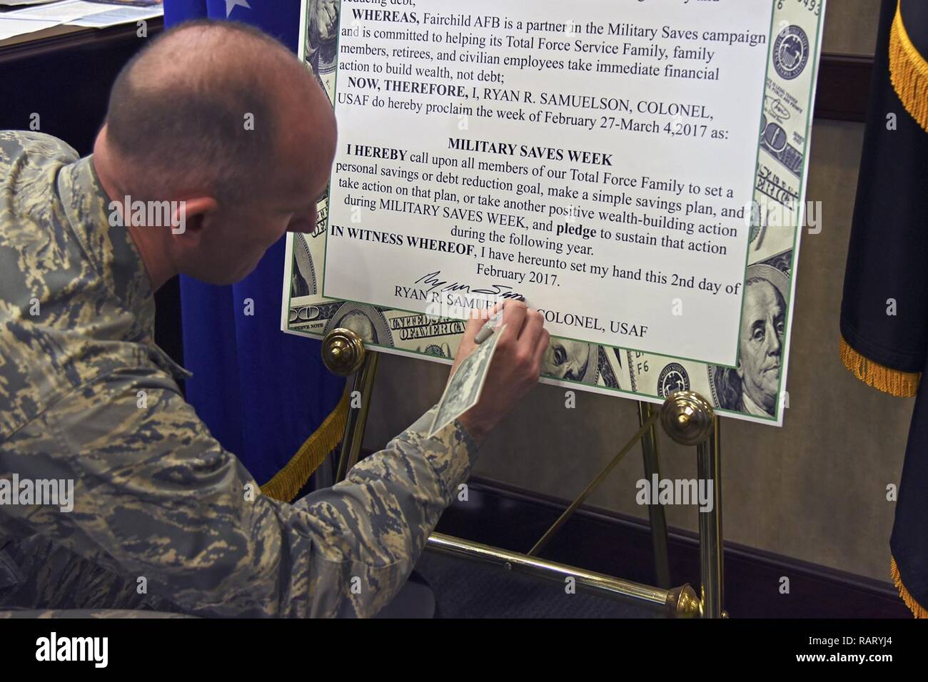 Col. Ryan Samuelson, 92nd Air Refueling Wing commander, signs the ...