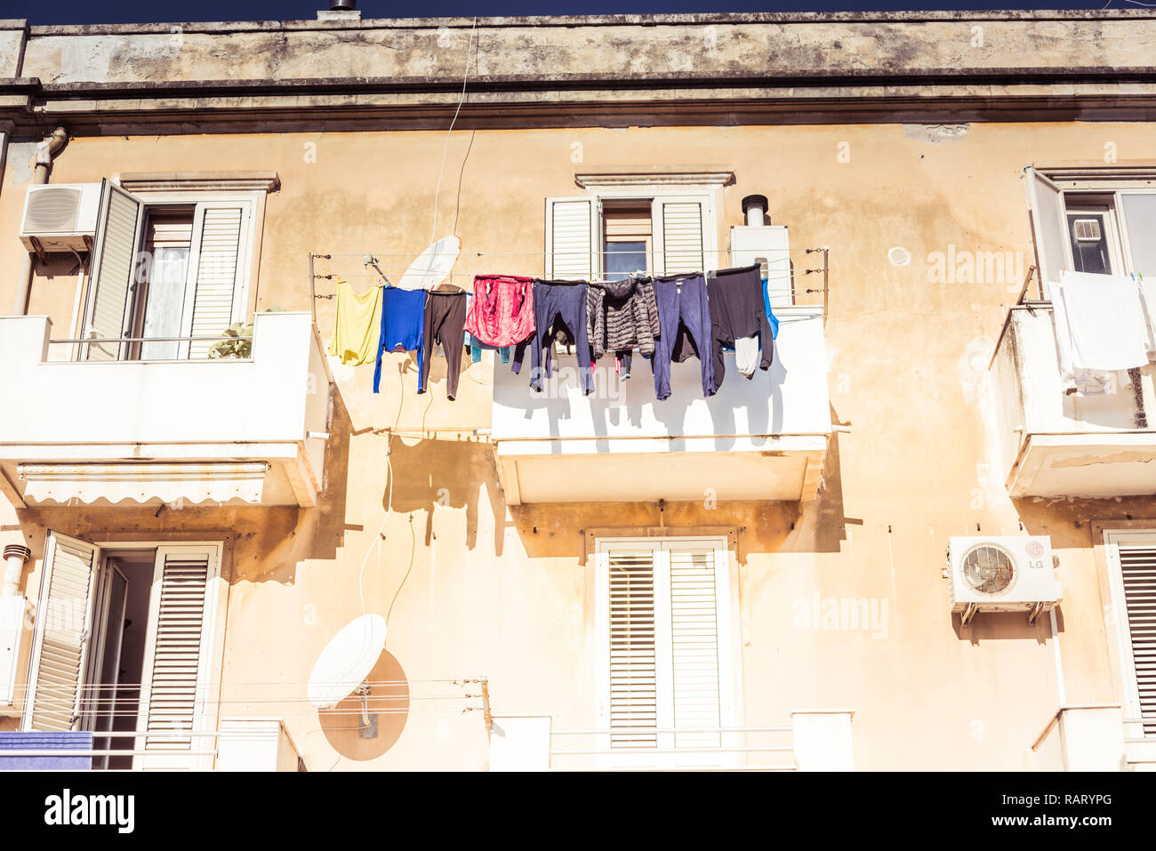 Laundry on the street and balcony Stock Photo - Alamy