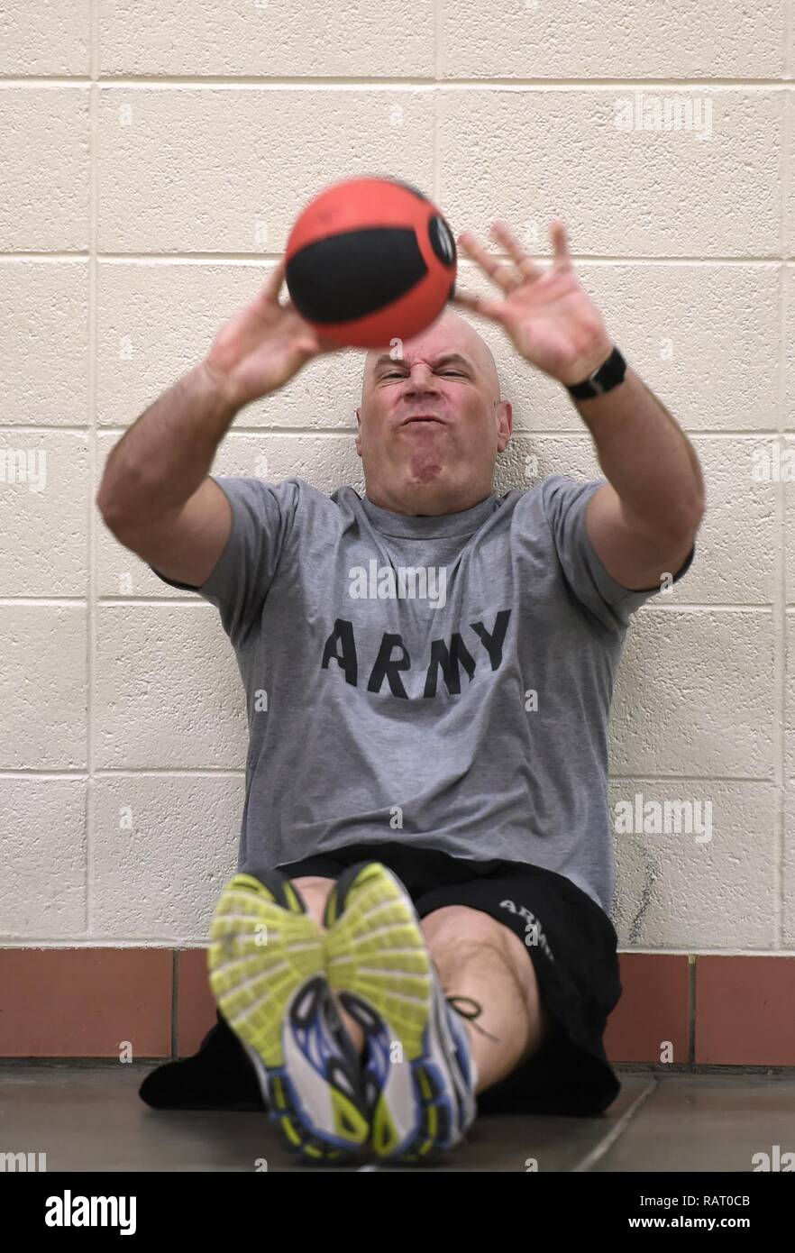 Lt. Col. Loren Thomson launches a 4.4-pound medicine ball while keeping ...