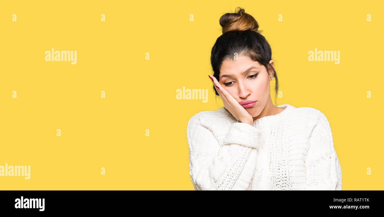 Young beautiful woman wearing winter sweater thinking looking tired and ...