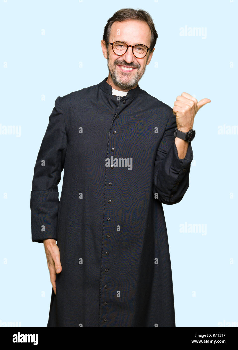 Middle age priest man wearing catholic robe smiling with happy face ...