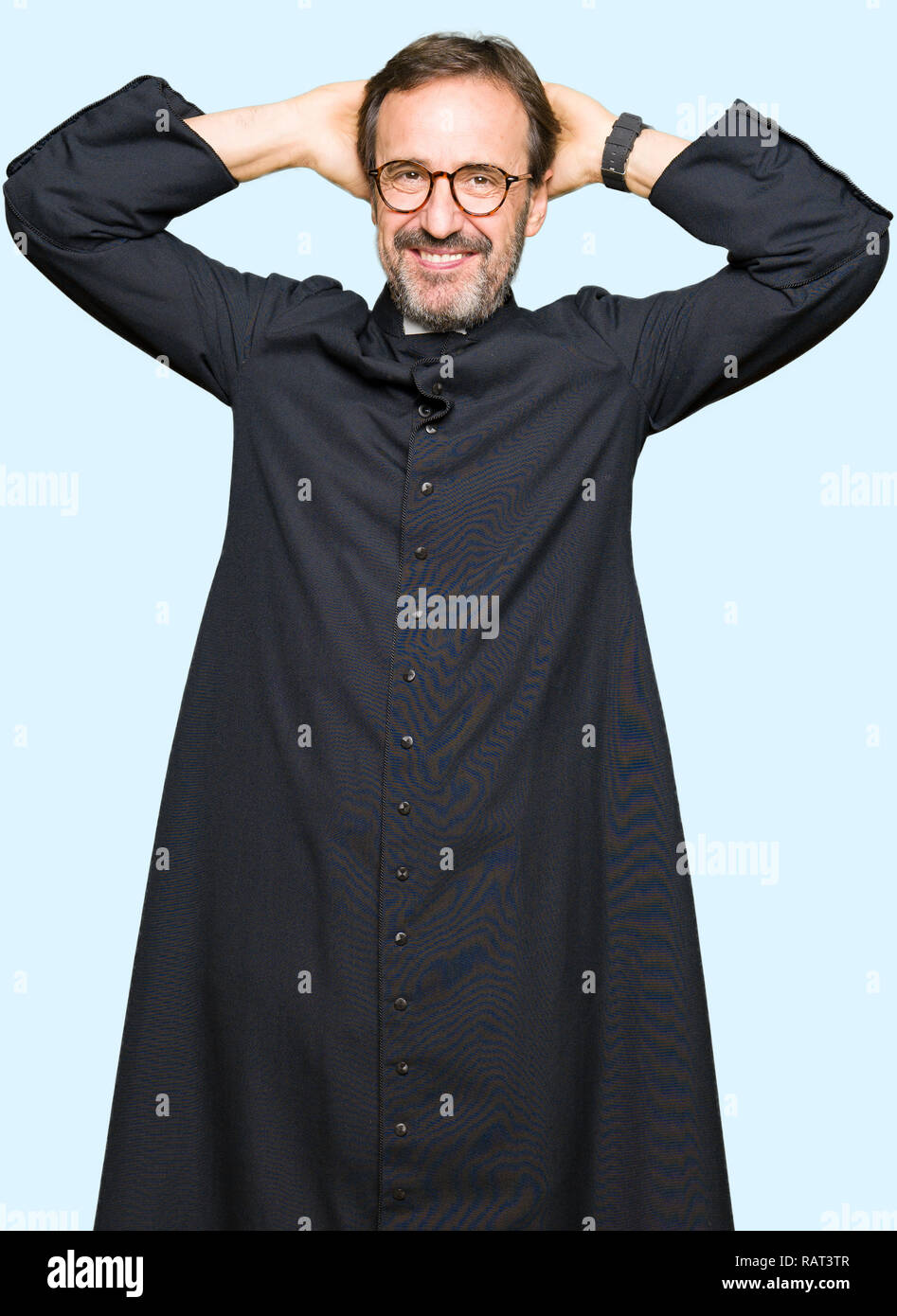 Middle age priest man wearing catholic robe Relaxing and stretching ...