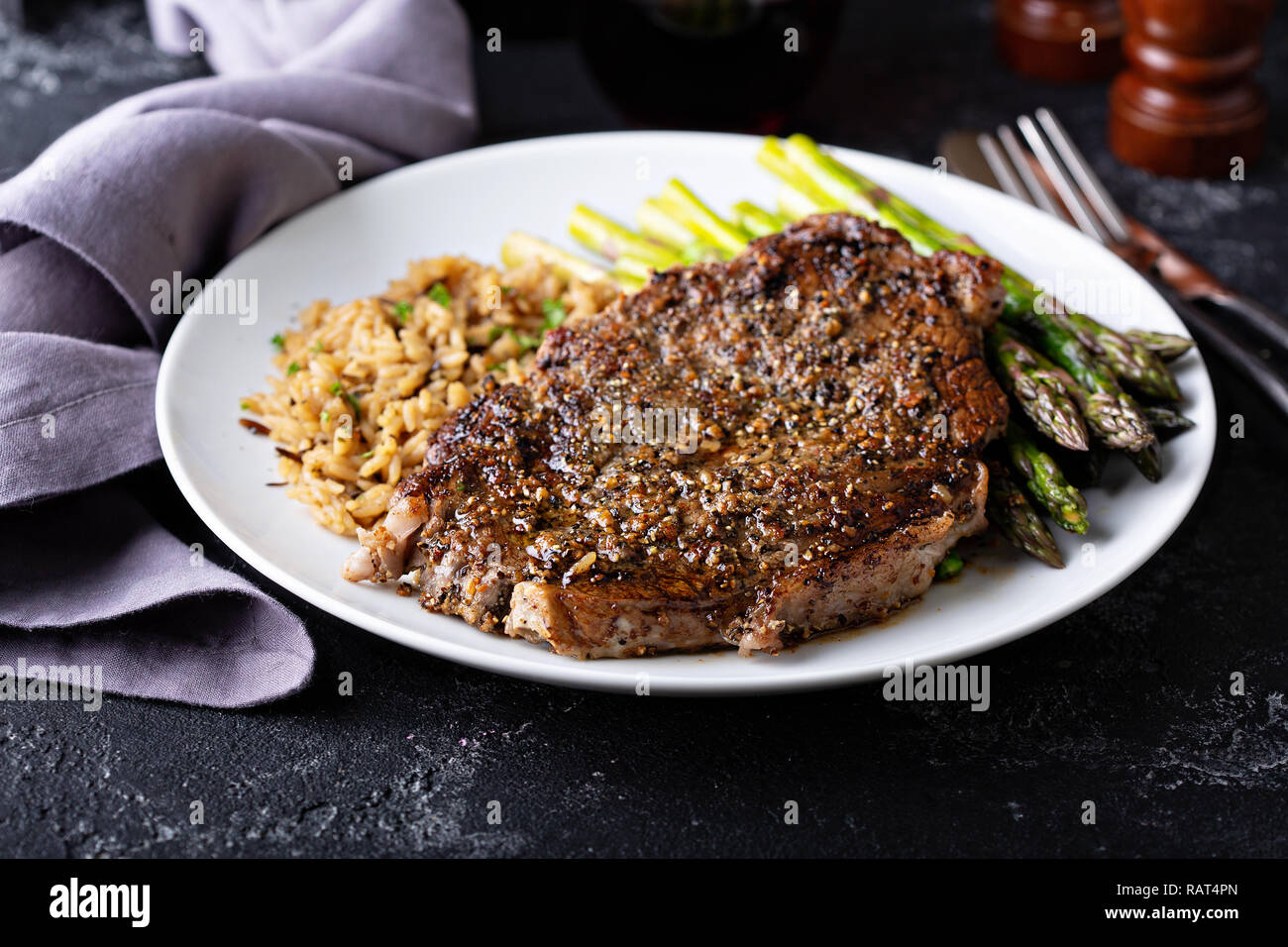Delisious steak on a plate served with rice and asparagus Stock Photo ...