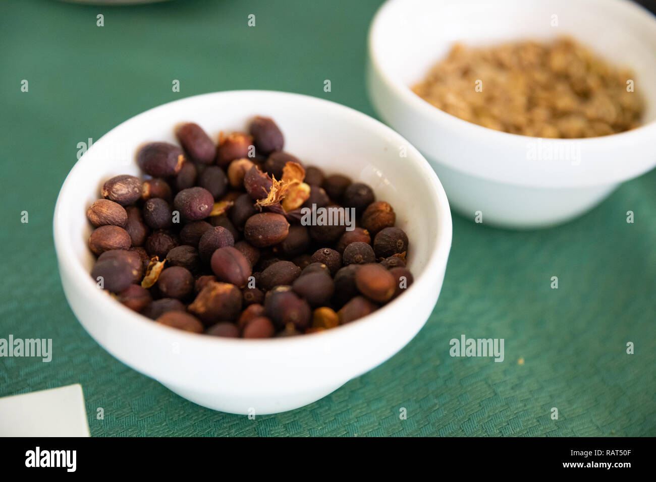 Two bowls of beans showing the process of coffee production Stock Photo ...