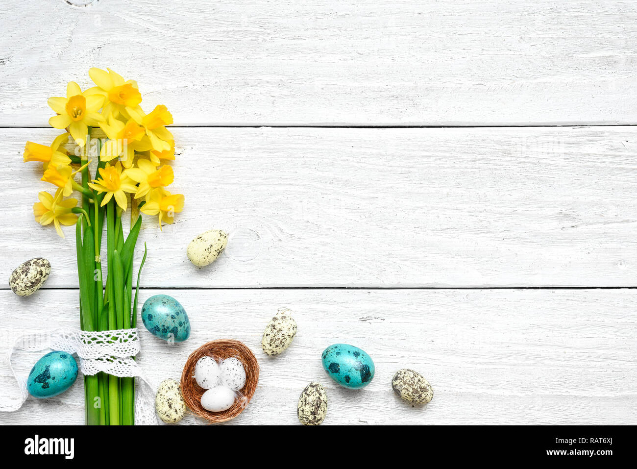 Easter Background with easter eggs and spring flowers on white wooden ...