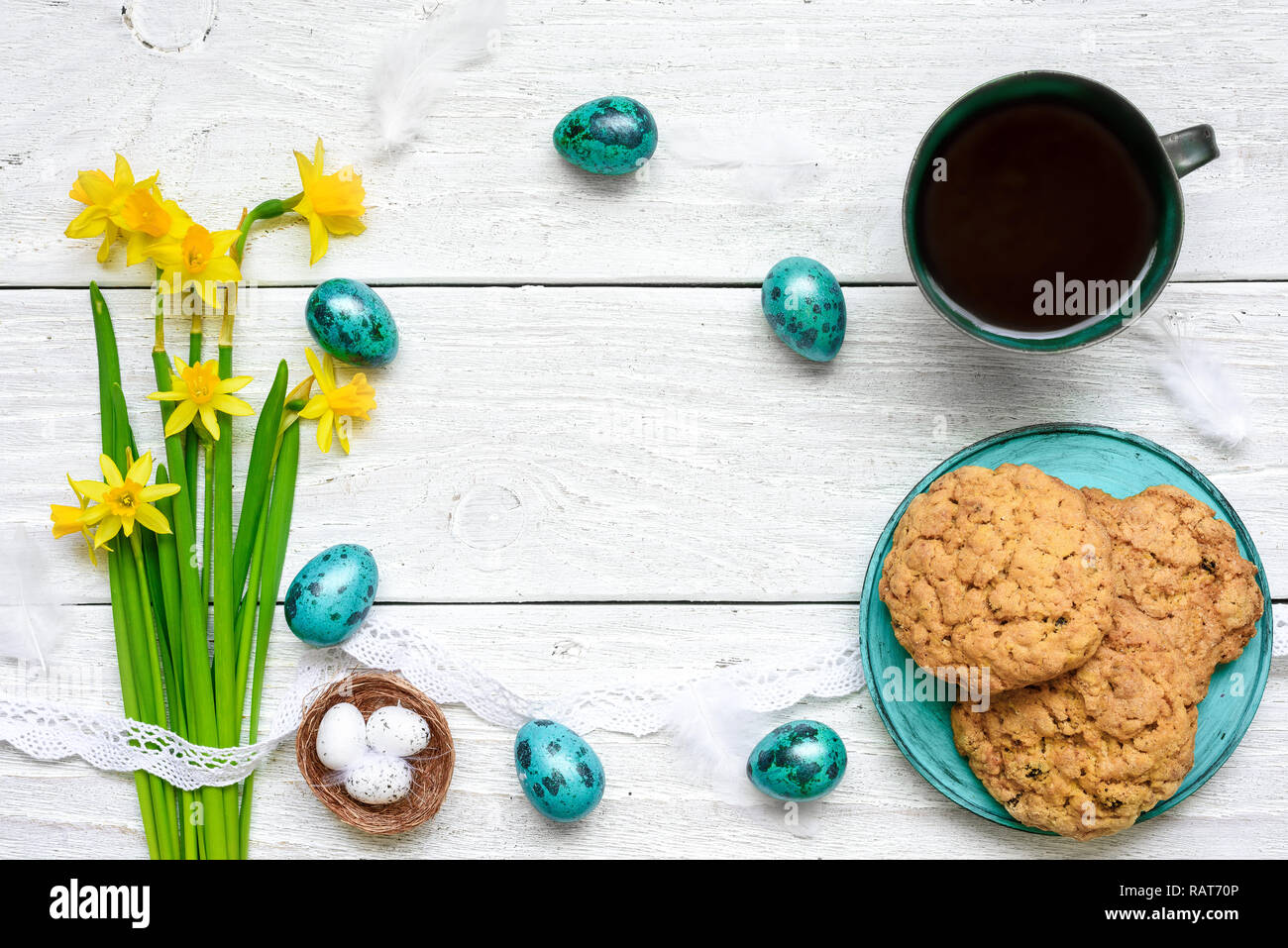 easter background with easter eggs, spring flowers, cup of coffee and ...