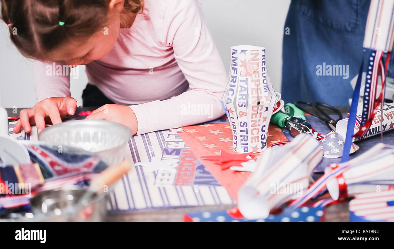 Step by step. Mother and daughter making paper firecrackers for July ...