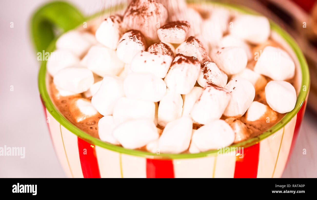 Garnishing American hot chocolate with marshmallow toppings Stock Photo ...