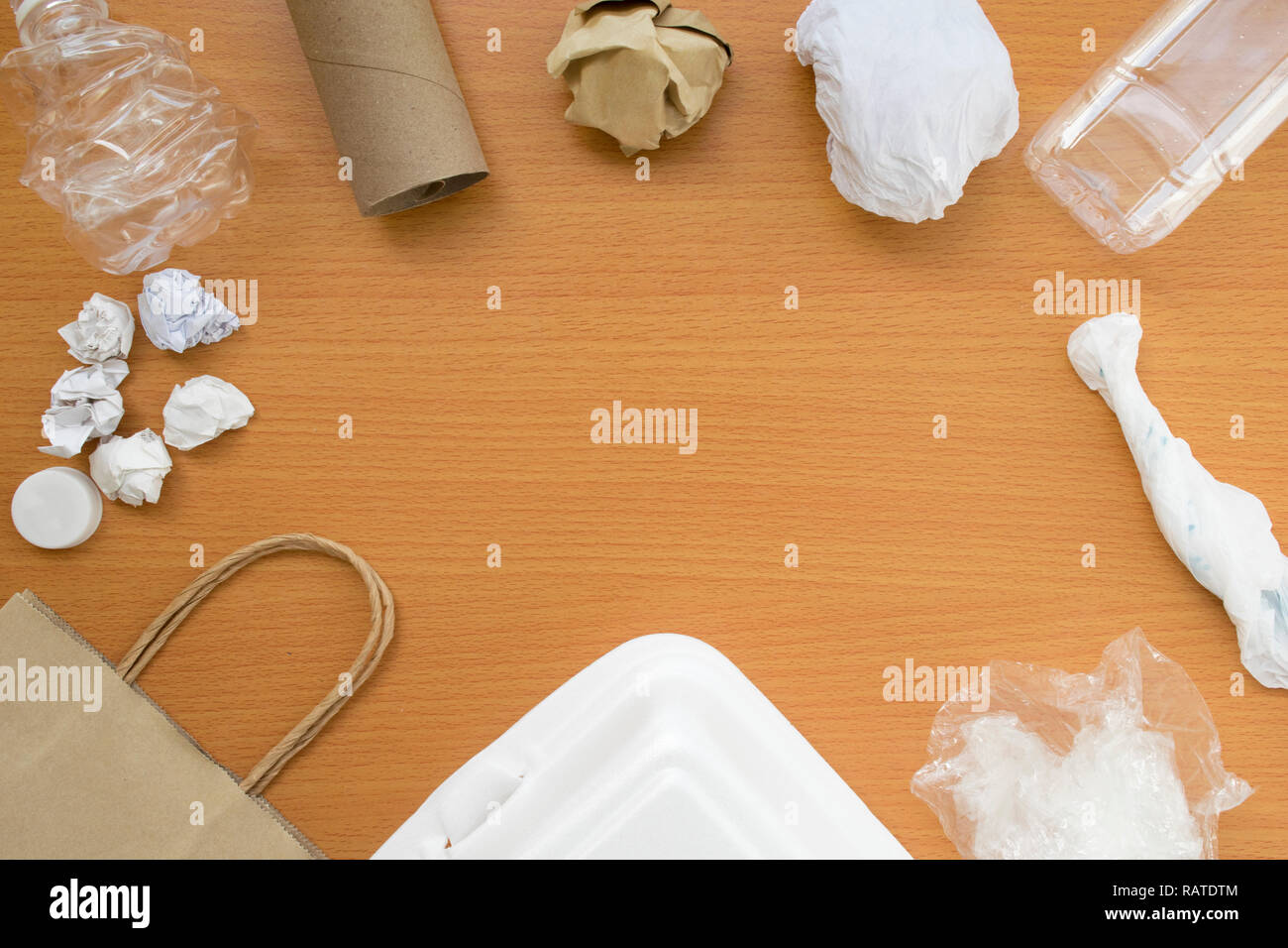 top view of recycling garbage waste on wooden background with center ...